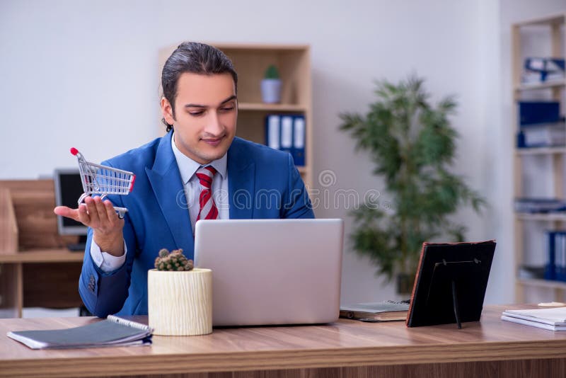 Young Male Employee in E-commerce Concept in the Office Stock Photo ...