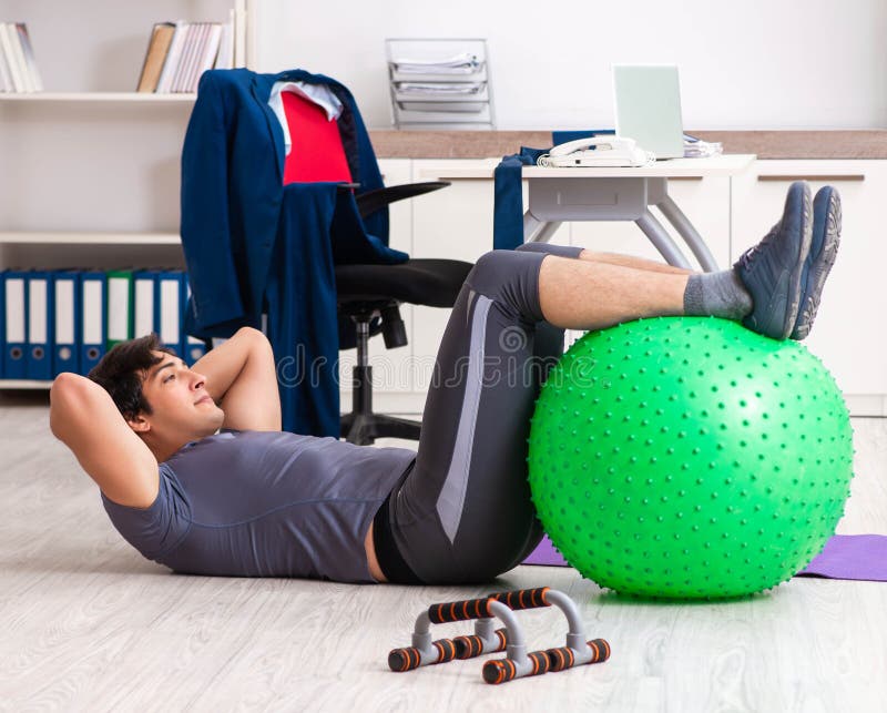 Young Male Employee Exercising in the Office Stock Image - Image of ...
