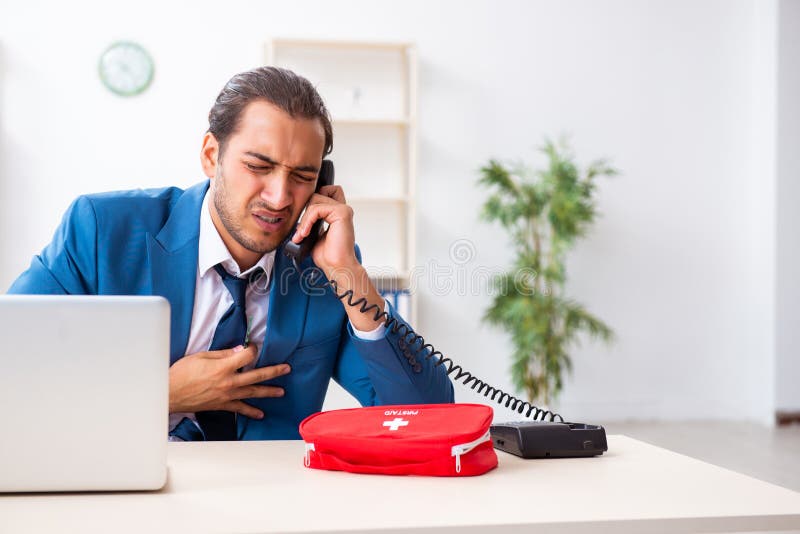 Young Male Employee in First Aid Concept Stock Photo - Image of boss ...