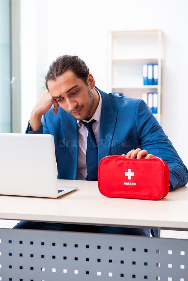 Young Male Employee in First Aid Concept Stock Image - Image of ...