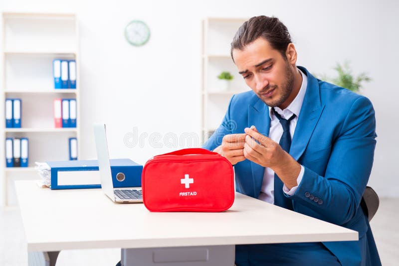 Young Male Employee in First Aid Concept Stock Photo - Image of needle ...