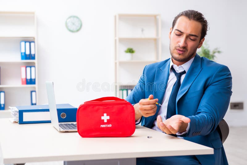 Young Male Employee in First Aid Concept Stock Image - Image of ...