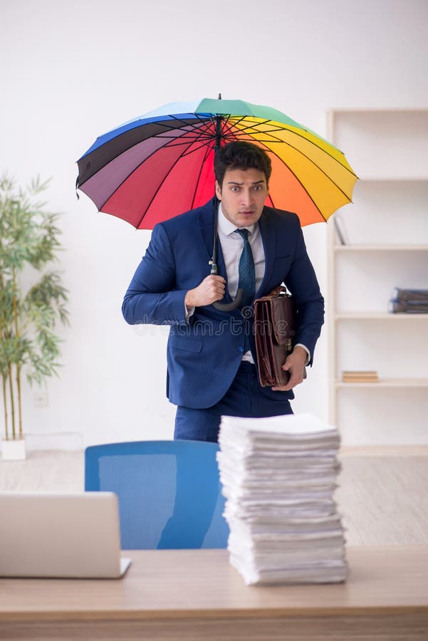 Young Male Employee Holding an Umbrella in the Office Stock Photo ...