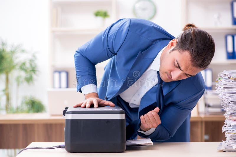 Young Male Employee Making Copies at Copying Machine Stock Photo ...