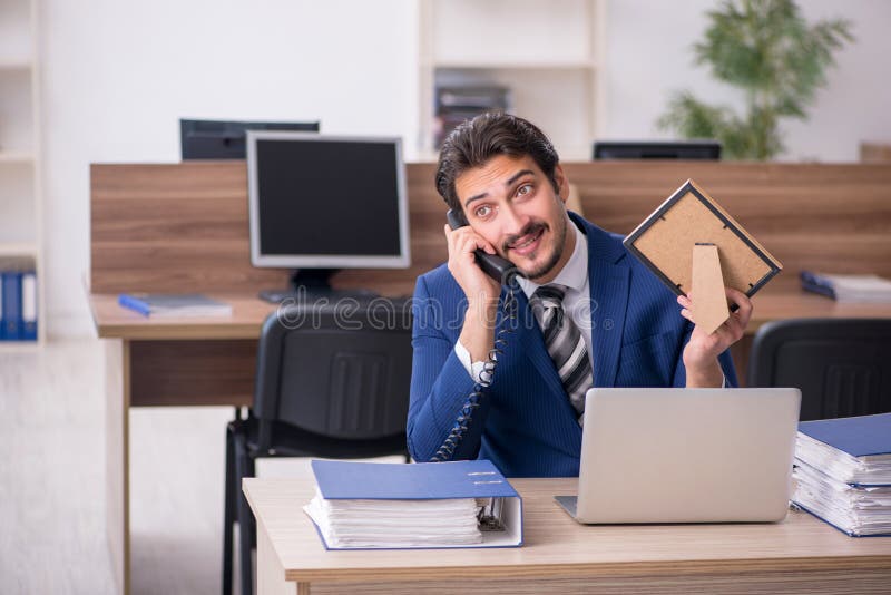 Young Male Employee Missing Girlfriend at Workplace Stock Image - Image ...