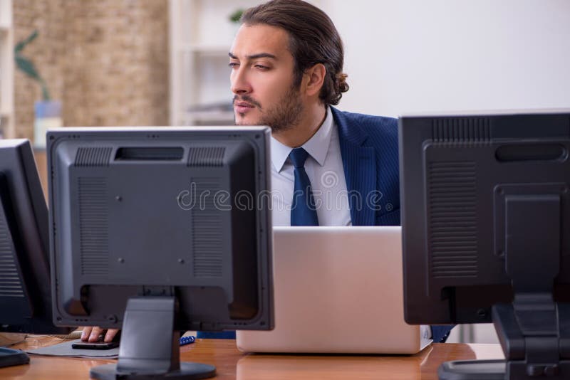Young Male Employee in Multitasking Concept Stock Photo - Image of busy ...