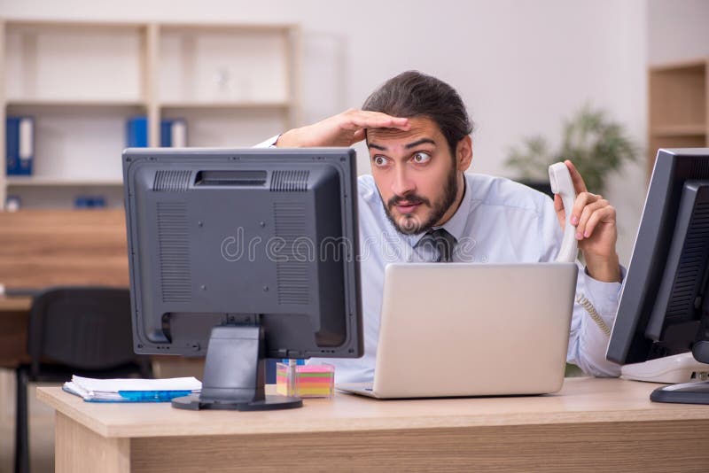 Young Male Employee in Multitasking Concept Stock Image - Image of ...