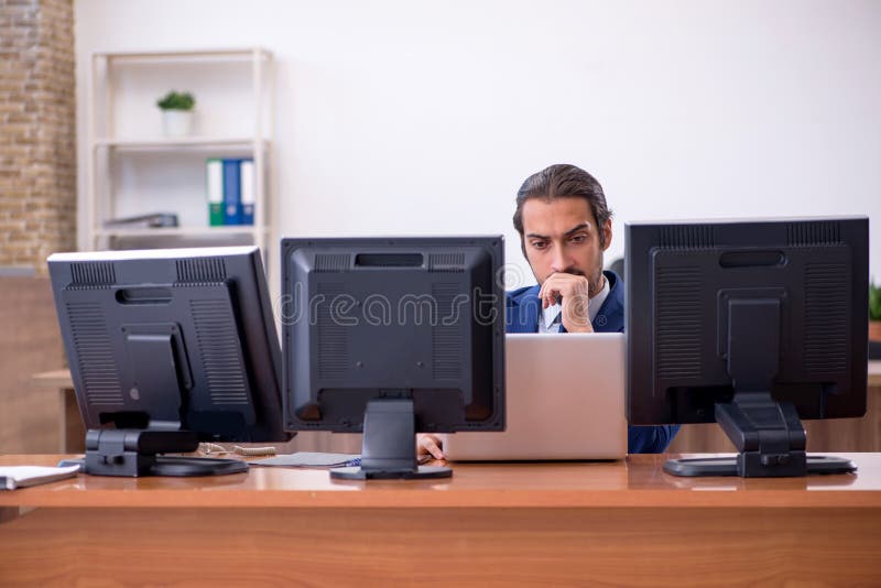 Young Male Employee in Multitasking Concept Stock Photo - Image of ...