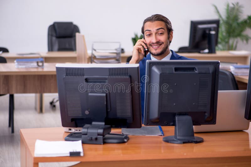 Young Male Employee in Multitasking Concept Stock Photo - Image of ...
