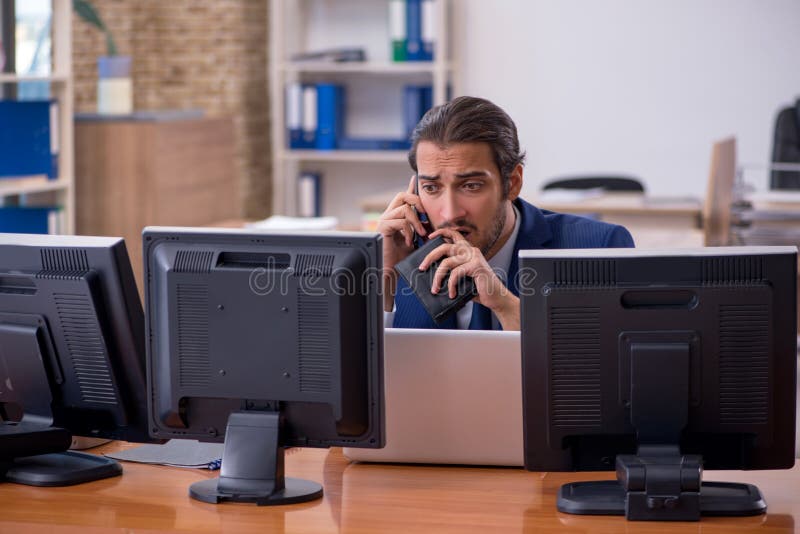 Young Male Employee in Multitasking Concept Stock Photo - Image of ...