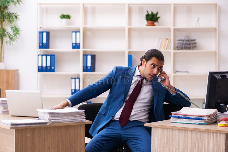 Young Male Employee in Multitasking Concept Stock Image - Image of ...