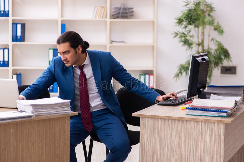 Young Male Employee in Multitasking Concept Stock Image - Image of ...
