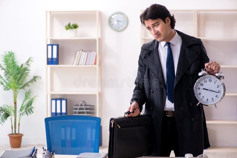 The Young Male Employee in the Office in Time Management Concept Stock ...