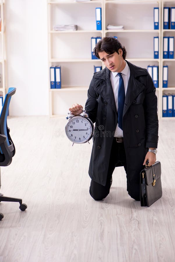 Young Male Employee in the Office in Time Management Concept Stock ...