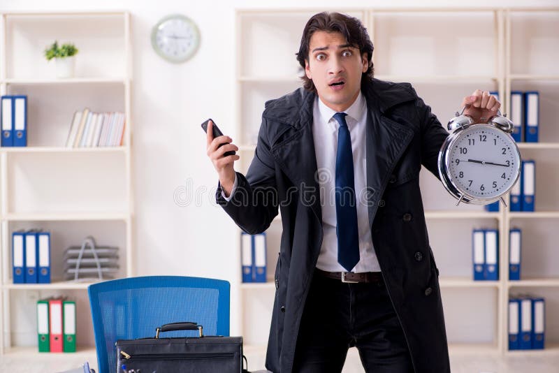 The Young Male Employee in the Office in Time Management Concept Stock ...