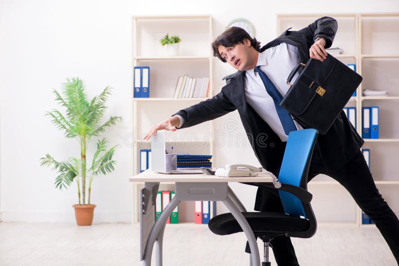 Young Male Employee in the Office in Time Management Concept Stock ...