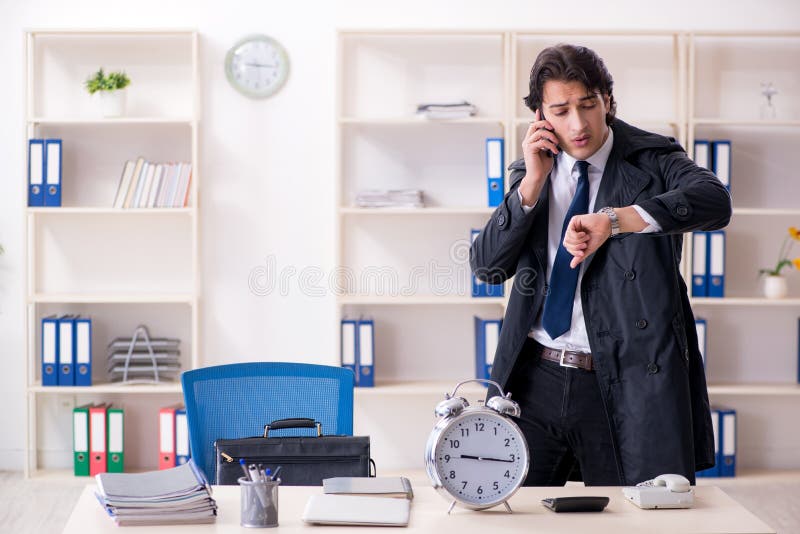 Young Male Employee in the Office in Time Management Concept Stock ...