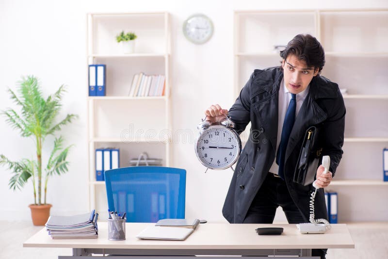 Young Male Employee in the Office in Time Management Concept Stock ...