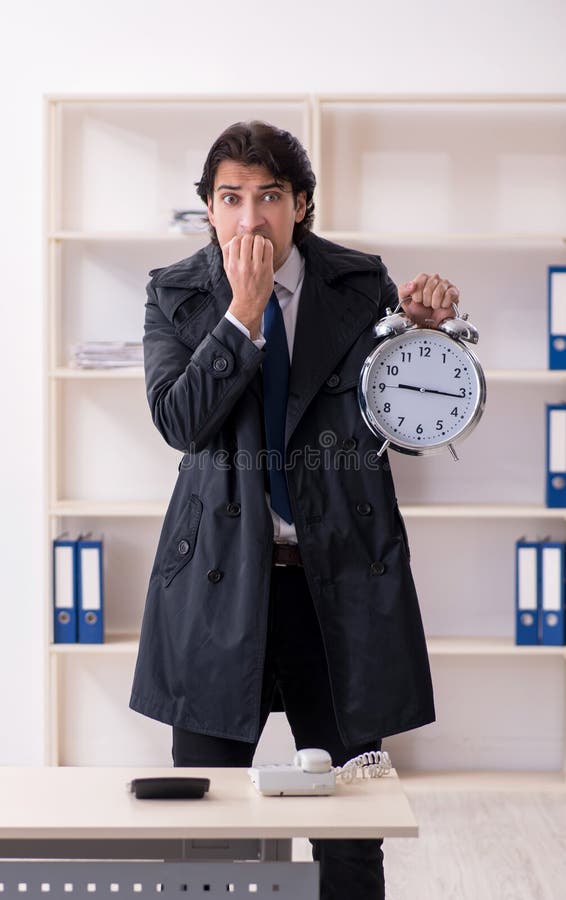 Young Male Employee in the Office in Time Management Concept Stock ...