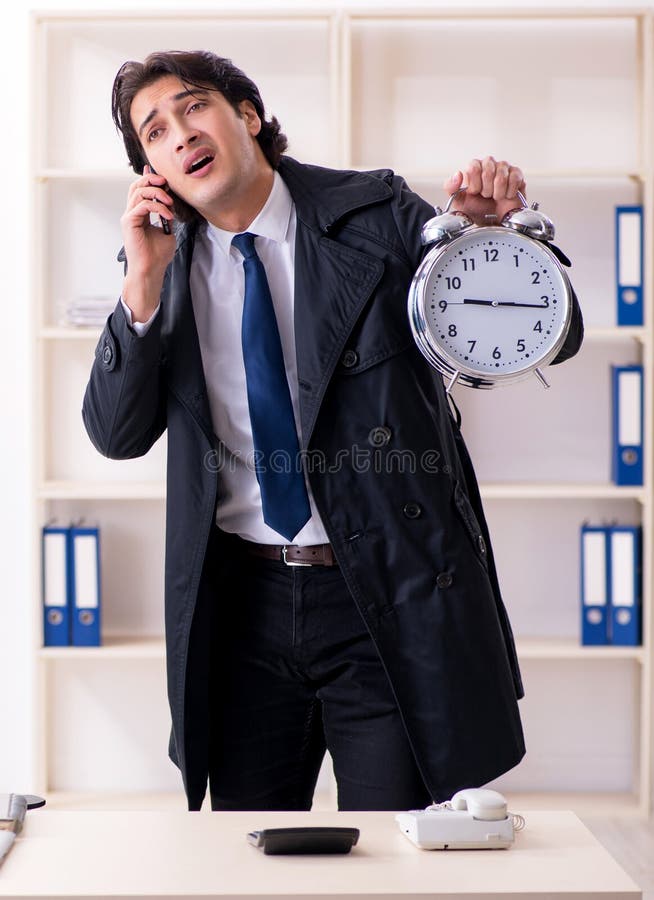 Young Male Employee in the Office in Time Management Concept Stock ...