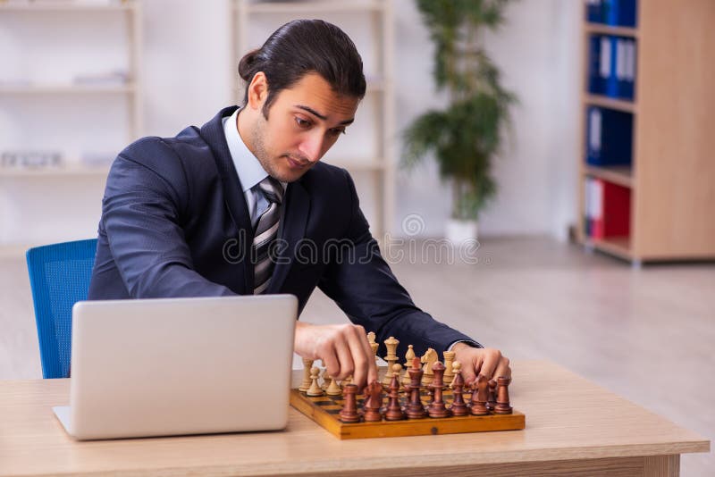 Young Male Employee Playing Chess at Workplace Stock Photo - Image of ...