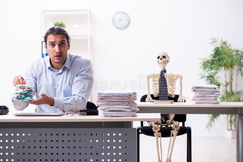 Young Male Employee and Skeleton in the Office Stock Photo - Image of ...
