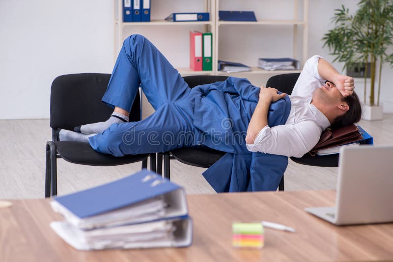 Young Male Employee Sleeping in the Office on Chairs Stock Photo ...