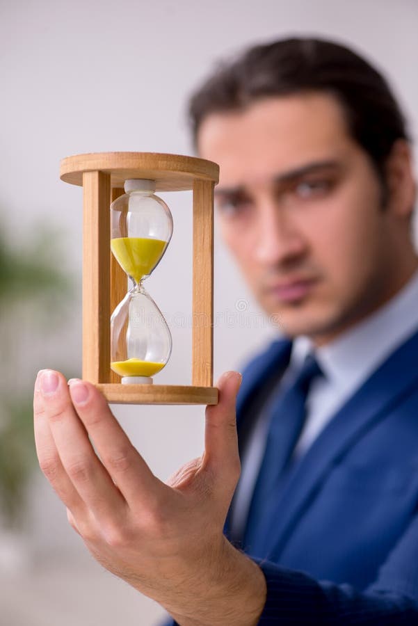 Young Male Employee in Time Management Concept Stock Image - Image of ...