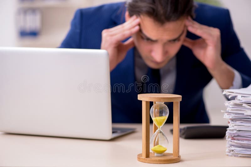 Young Male Employee in Time Management Concept Stock Photo - Image of ...