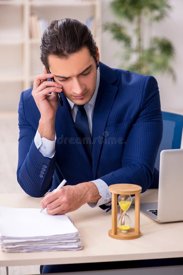 Young Male Employee in Time Management Concept Stock Photo - Image of ...