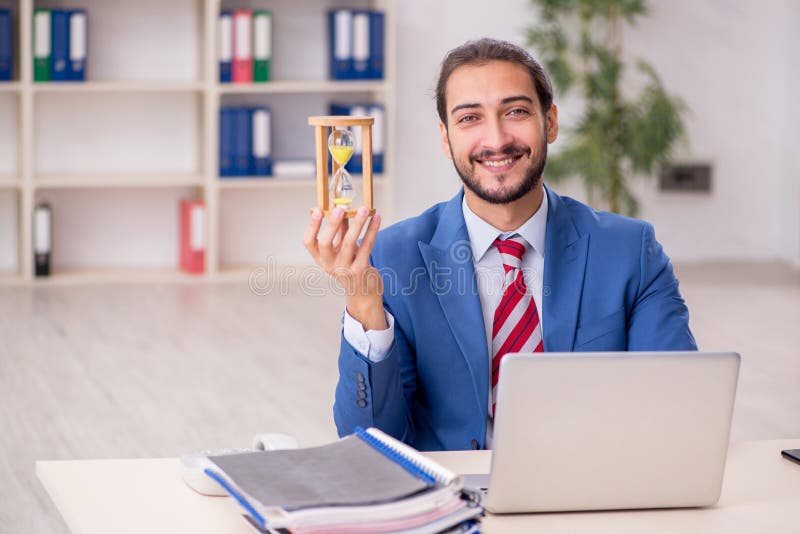 Young Male Employee in Time Management Concept Stock Image - Image of ...
