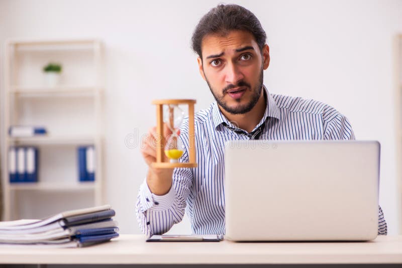 Young Male Employee in Time Management Concept Stock Image - Image of ...