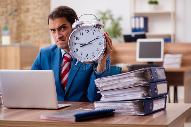 Young Male Employee in Time Management Concept Stock Photo - Image of ...