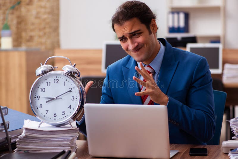 Young Male Employee in Time Management Concept Stock Photo - Image of ...