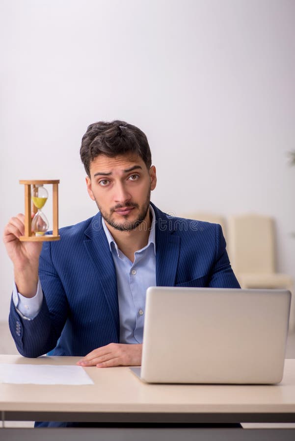 Young Male Employee in Time Management Concept Stock Photo - Image of ...