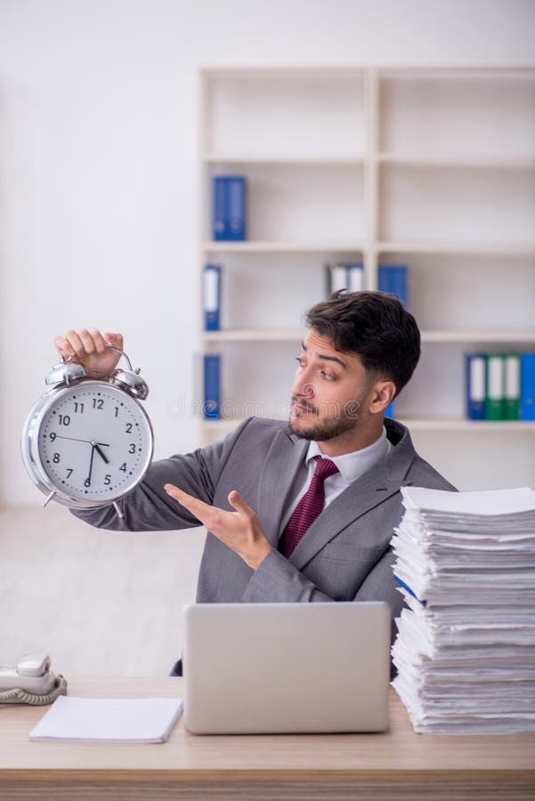 Young Male Employee in Time Management Concept Stock Image - Image of ...