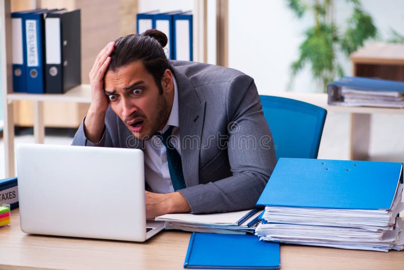 Young Male Employee and Too Much Work in the Office Stock Photo - Image ...