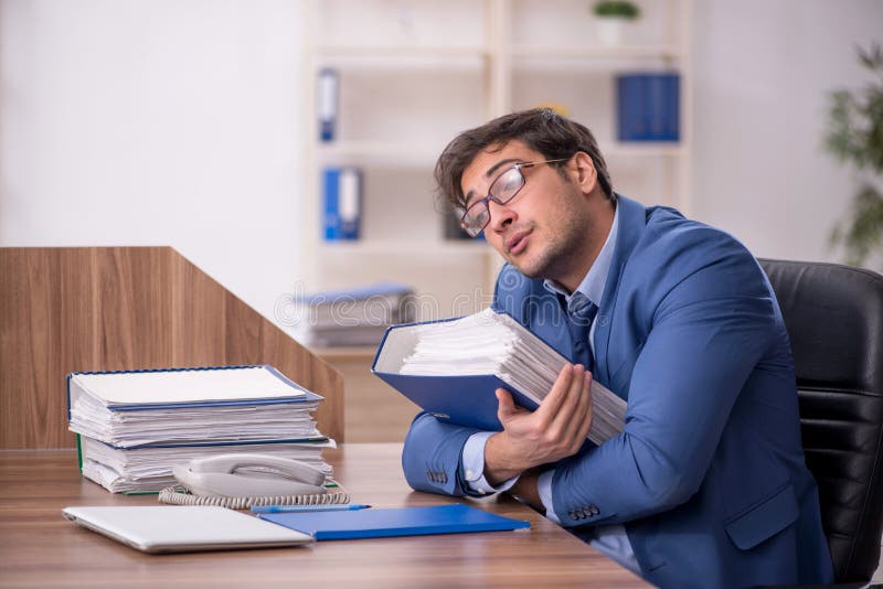 Young Male Employee and Too Much Work in the Office Stock Image - Image ...