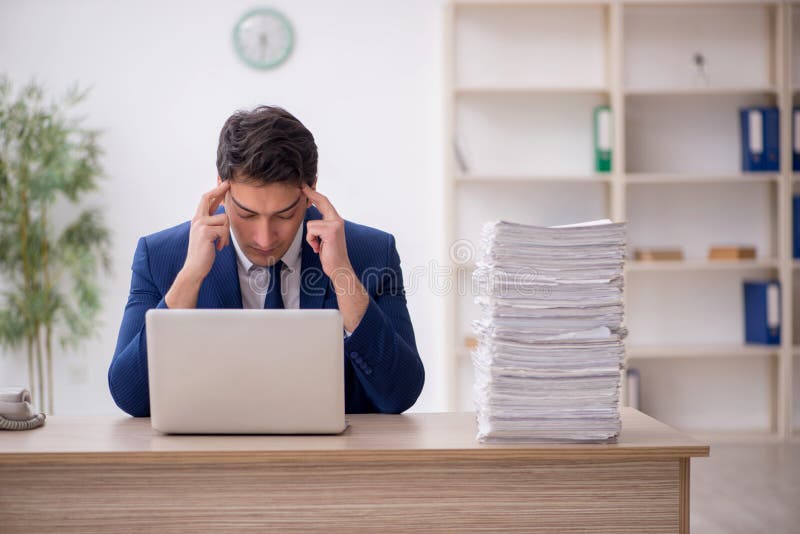 Young Male Employee and Too Much Work in the Office Stock Image - Image ...