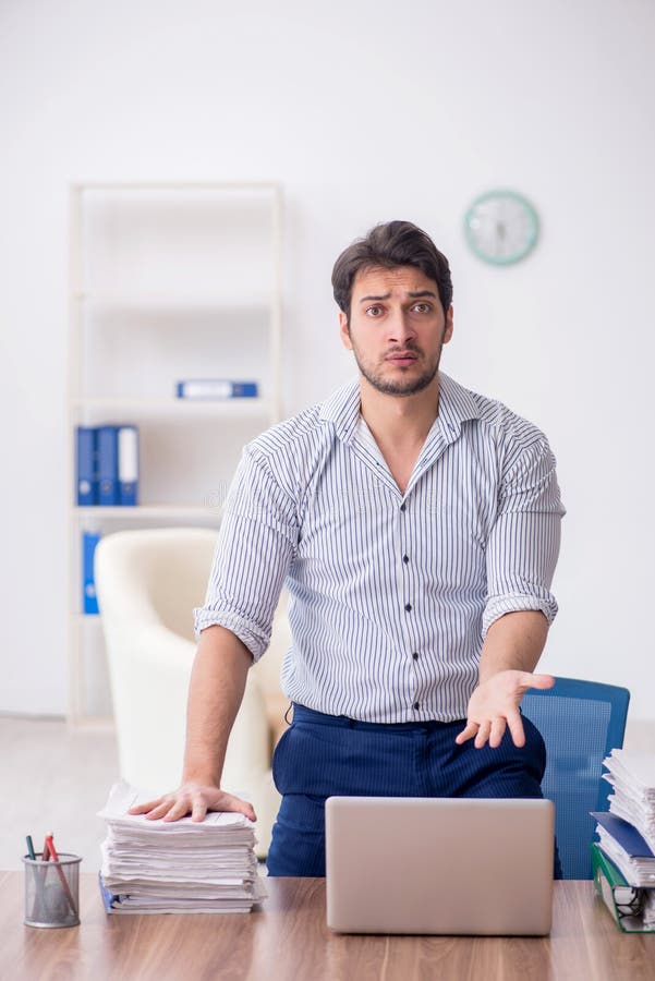 Young Male Employee and Too Much Work in the Office Stock Image - Image ...