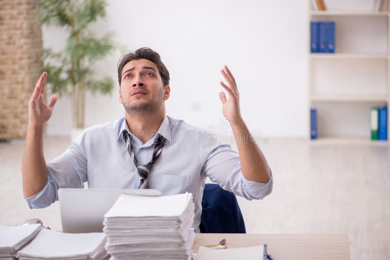Young Male Employee and Too Much Work in the Office Stock Photo - Image ...