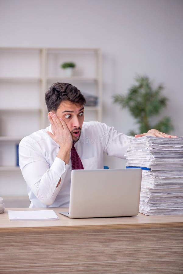 Young Male Employee and Too Much Work in the Office Stock Photo - Image ...