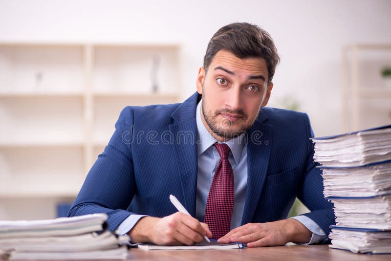 Young Male Employee and Too Much Work in the Office Stock Photo - Image ...