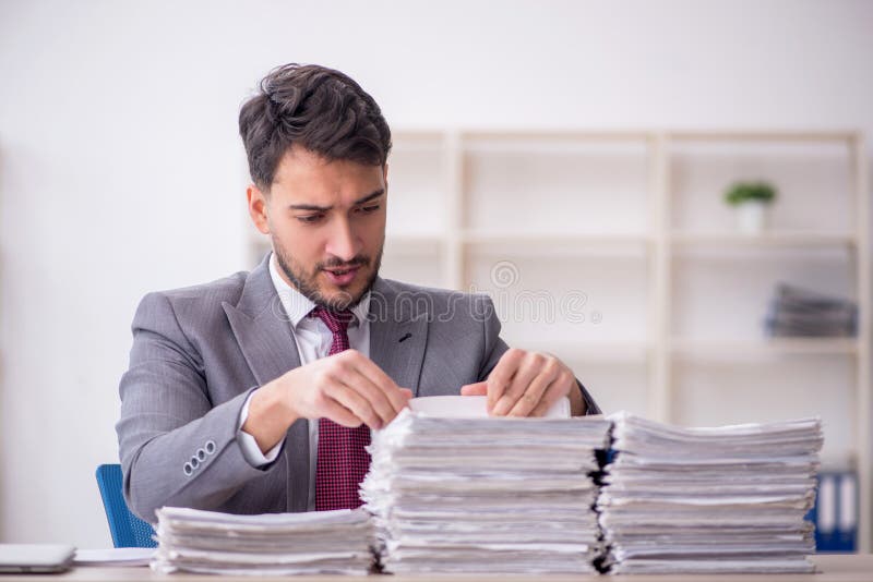 Young Male Employee and Too Much Work in the Office Stock Photo - Image ...