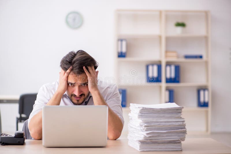 Young Male Employee and Too Much Work in the Office Stock Image - Image ...