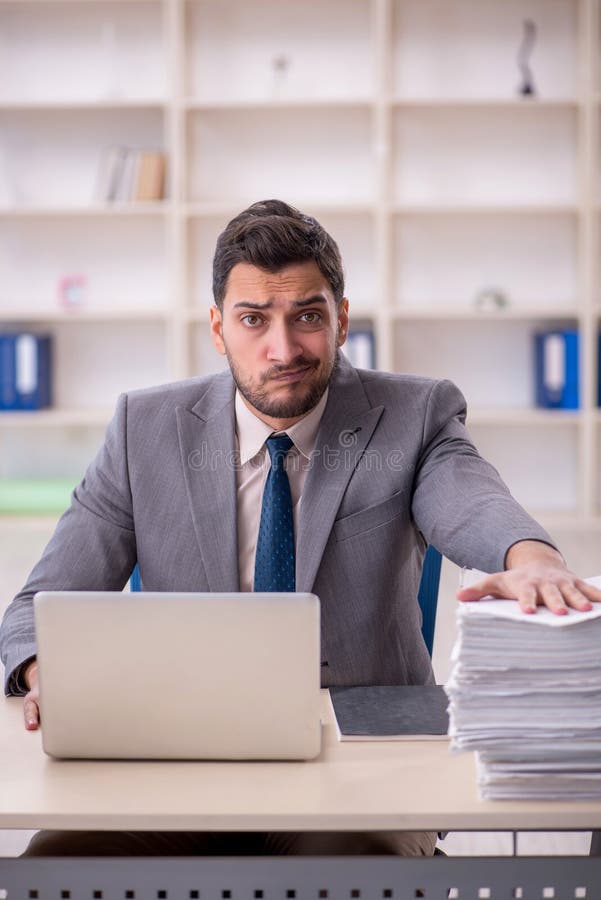 Young Male Employee Unhappy with Excessive Work in the Office Stock ...