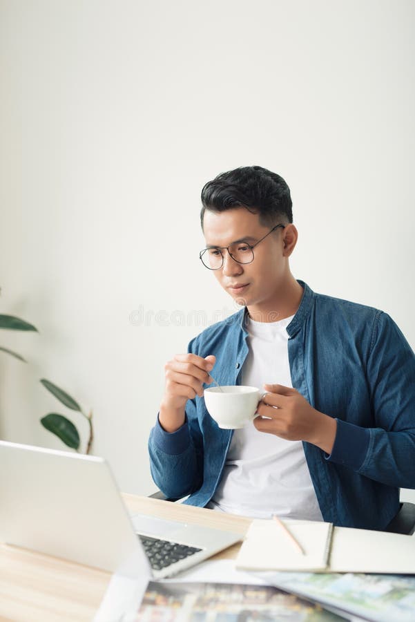 Young Male Engineer or Accountant with Pen and Cup of Coffee Making ...