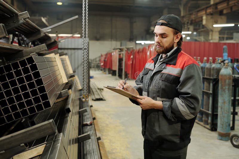 Young Male Engineer with Document Making Notes about Construction ...