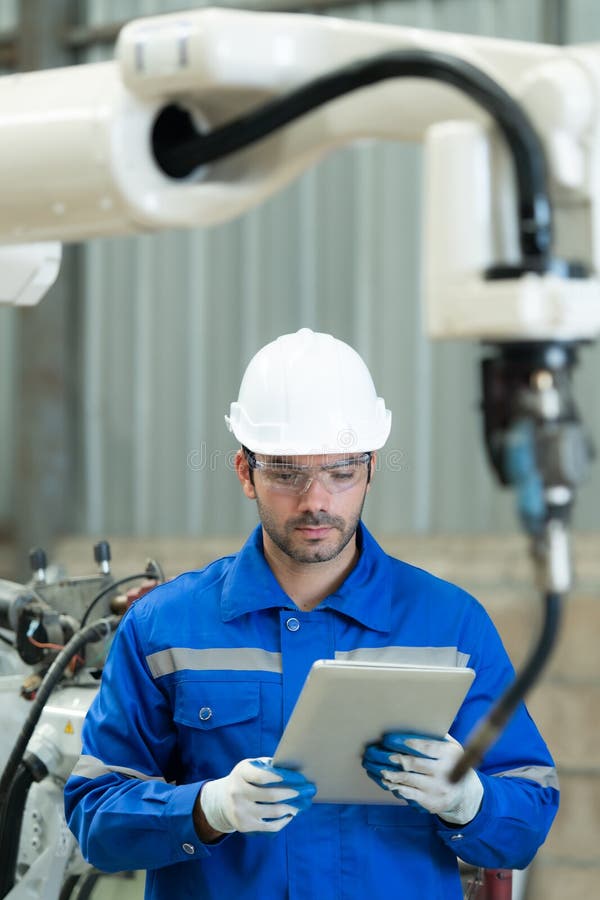Young Male Engineers are Manipulating a Welding Robot Hand. by ...
