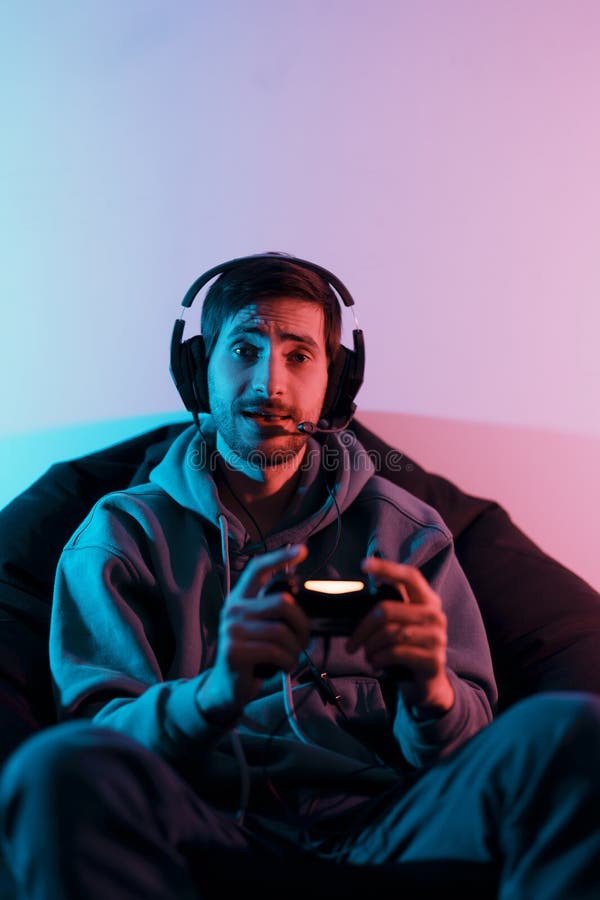 Happy Male Gamer in Headset with Gamepad Playing Video Game Stock Photo ...
